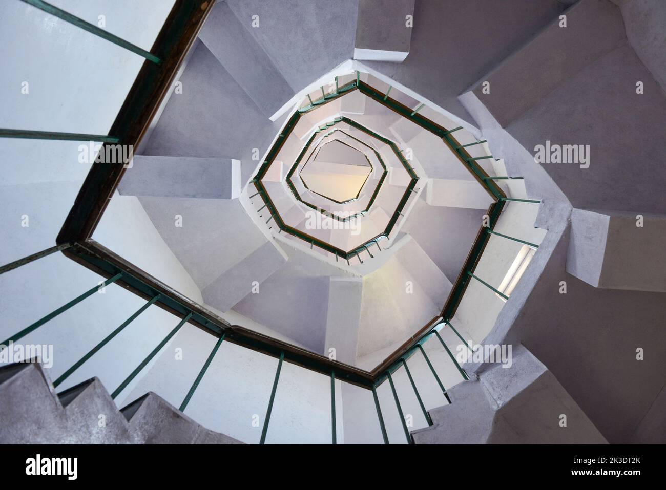 An upward view of a staircase with a railing Stock Photo - Alamy