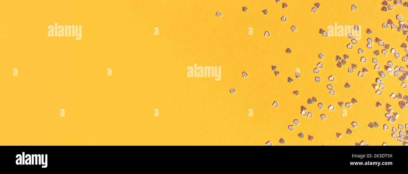 Banner with silver crystal confetti on a yellow background. Shimmer ...