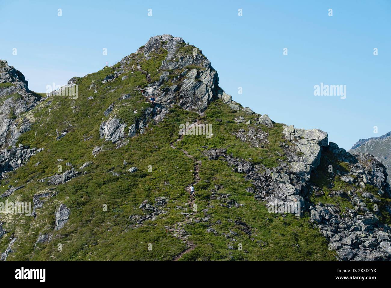 Norway-, western Norway, Sæbo, Trekker coming down from peak adjascent ...