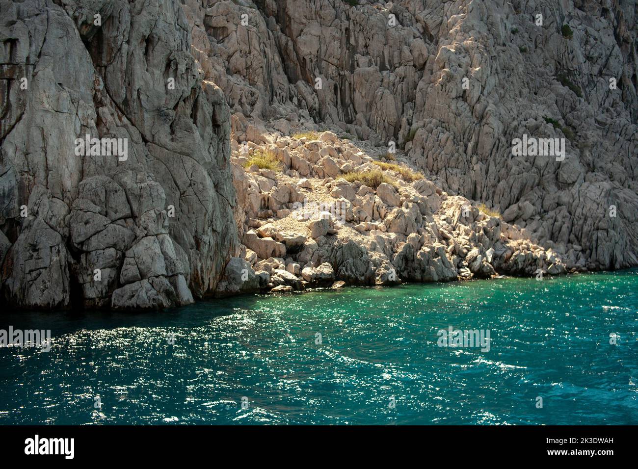 Aegean sea rocky shores with turquoise water. Lava stones and rocks ...