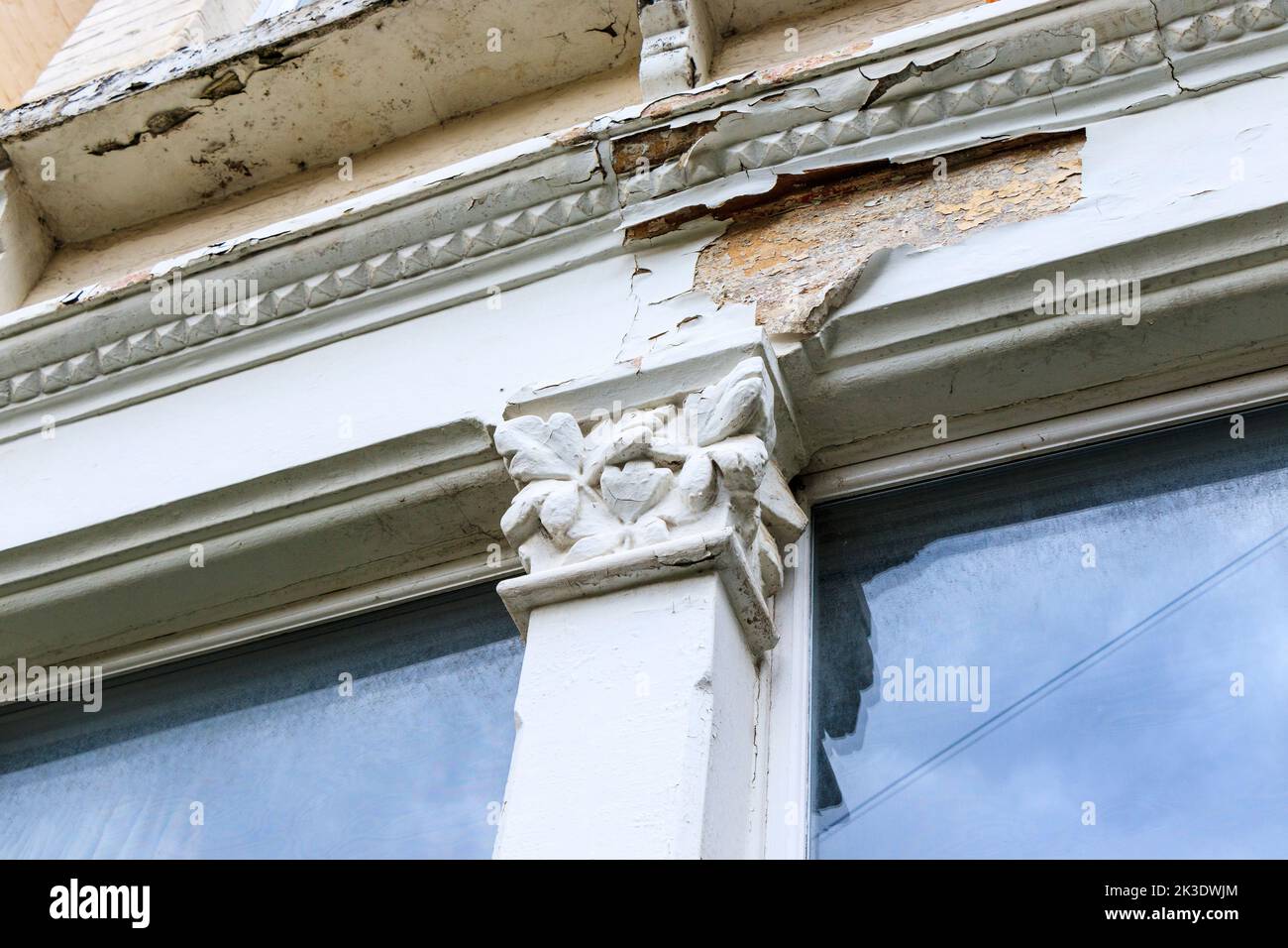 An ornate lintel in a state of disrepair in a Victorian residential ...
