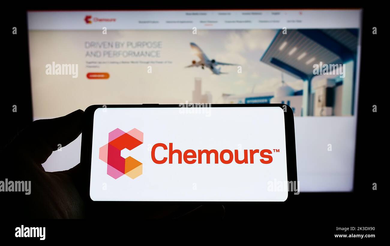 Person holding mobile phone with logo of US chemical manufacturer The ...