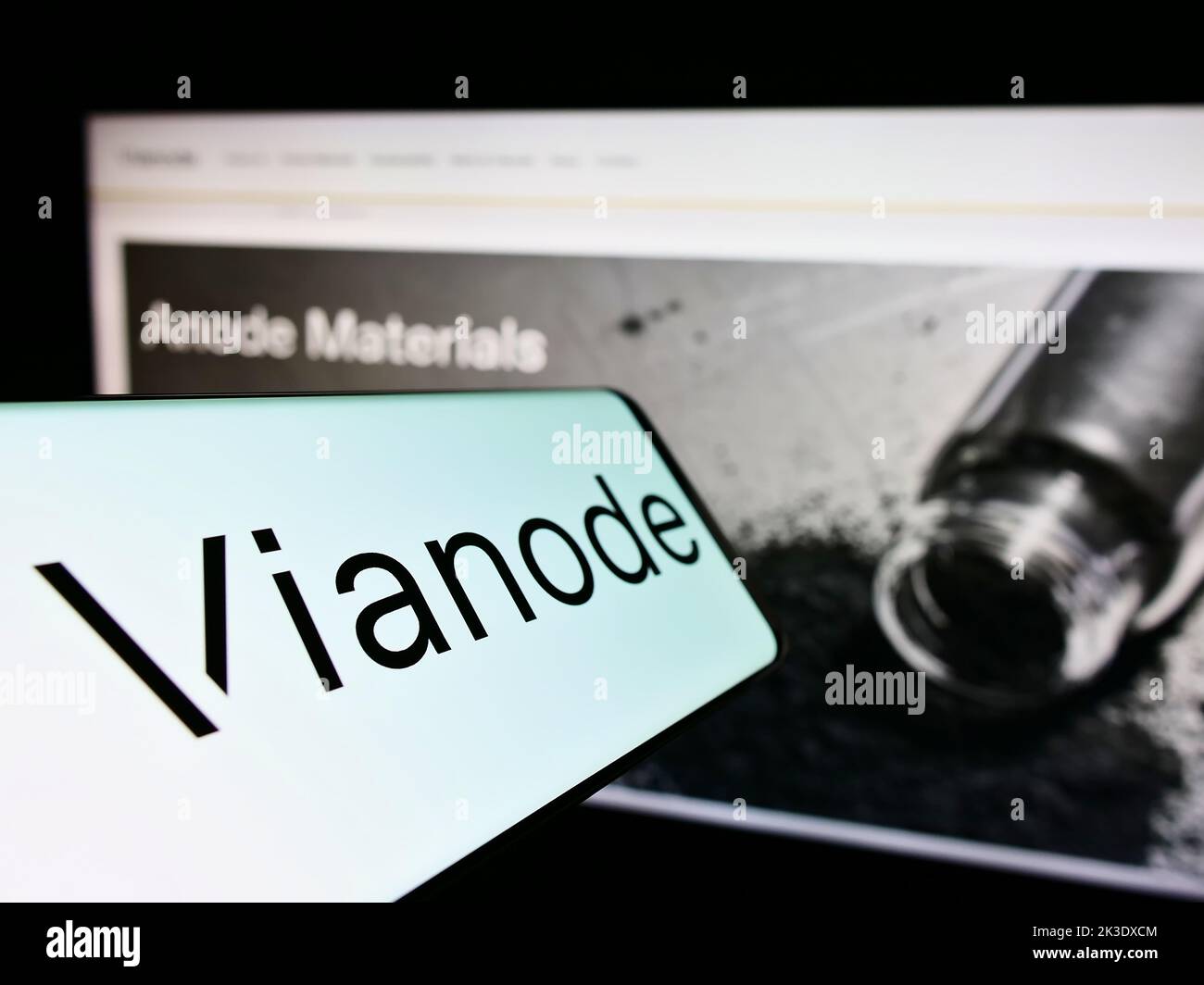 Cellphone with logo of Norwegian battery materials company Vianode on screen in front of ...