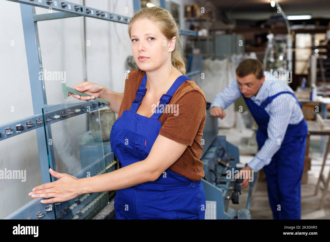 Female glazier measuring glass with caliper Stock Photo - Alamy