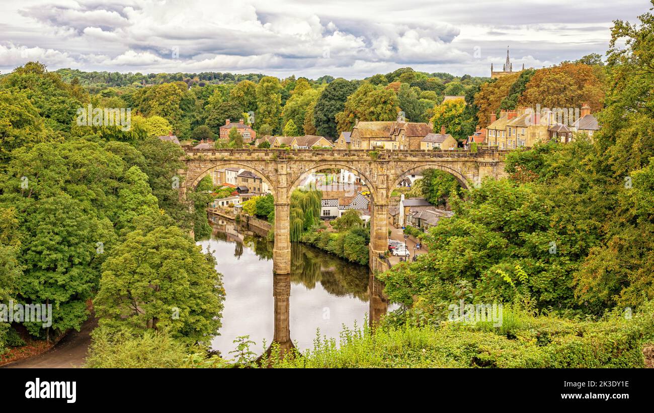A viaduct stretches over a deep valley with a river below. The scene is ...
