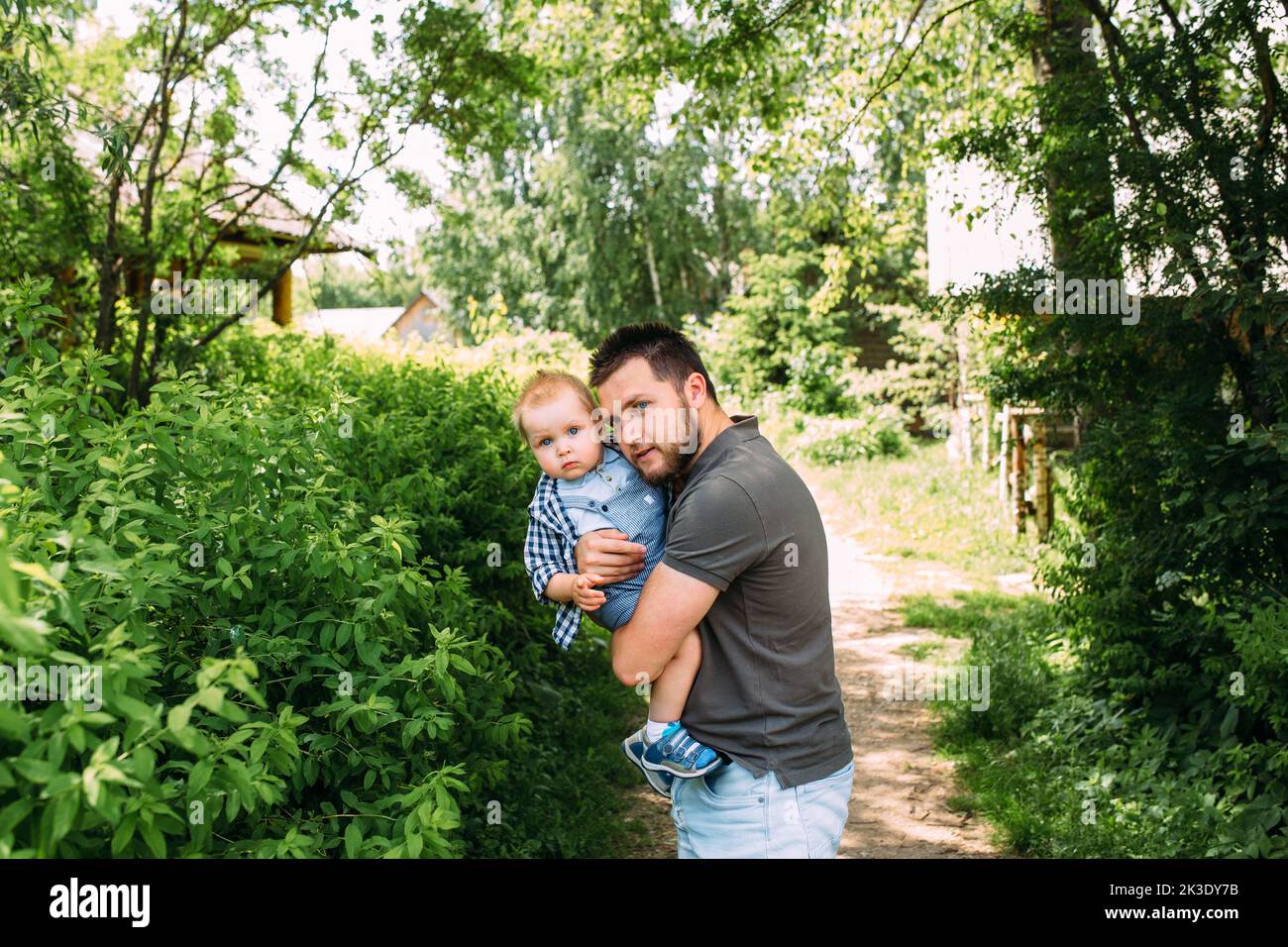 Dad and little son spend time together in the summer outdoors, have fun ...