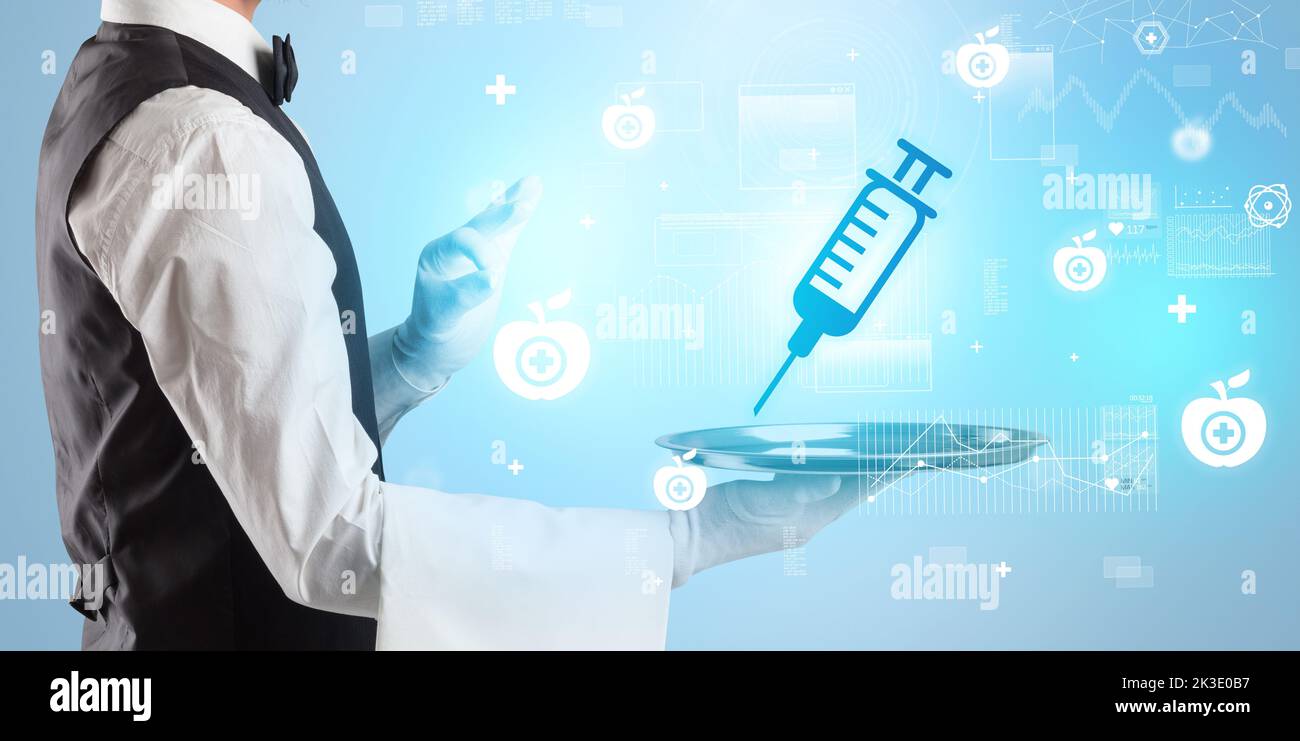 Handsome young waiter in tuxedo holding healthcare icons on tray Stock ...
