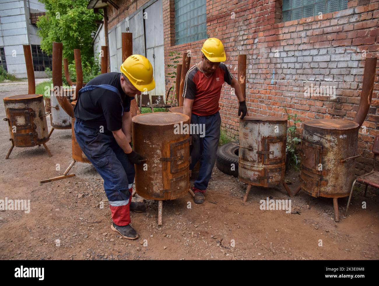 Workers of the Lviv utility company carry a ready-made special metal ...