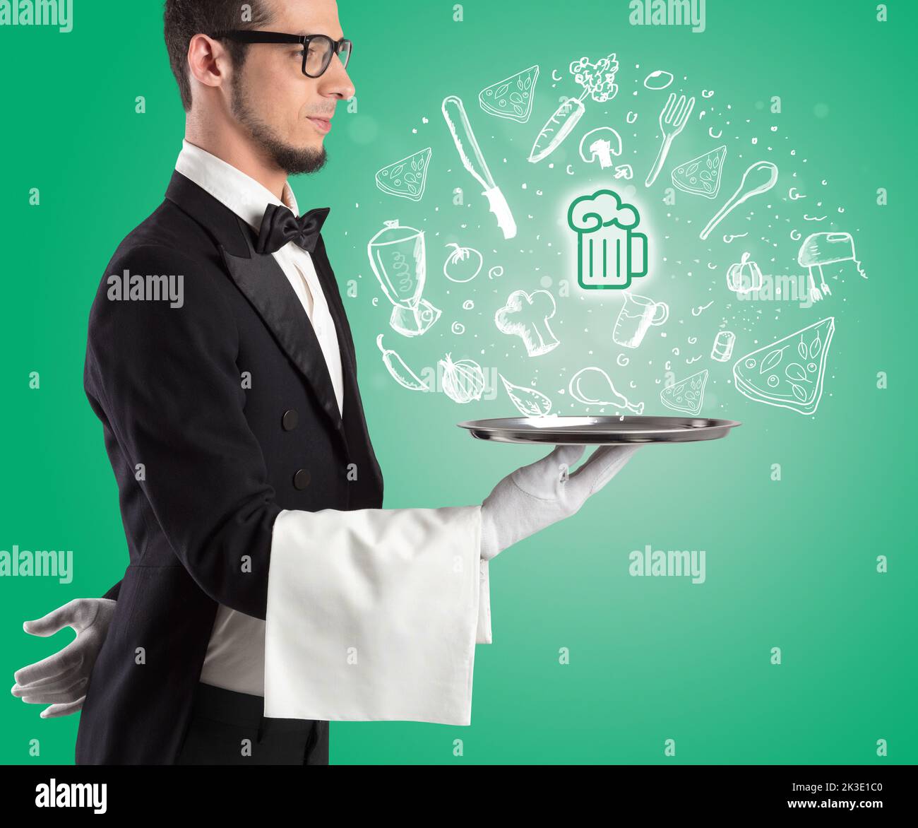 Waiter holding silver tray with food icons above Stock Photo - Alamy