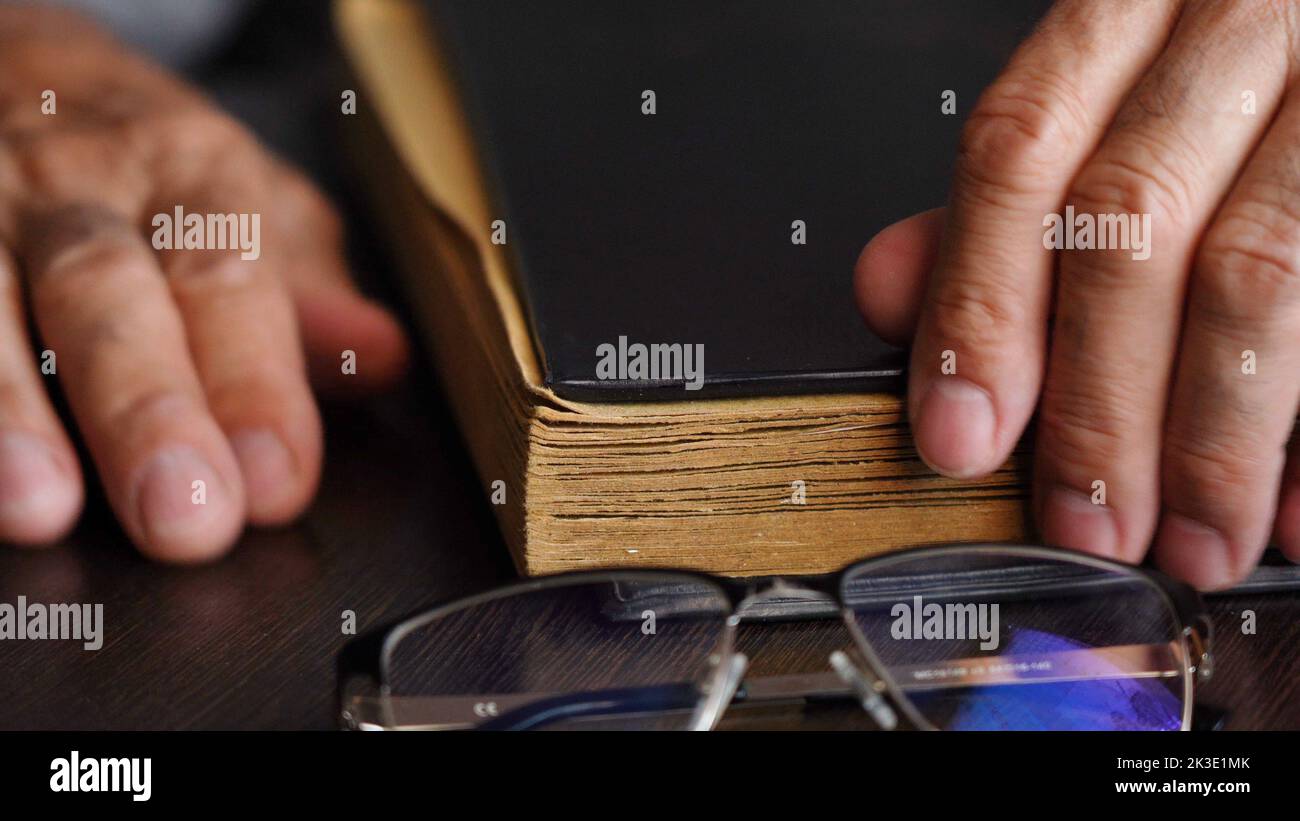 Hand holding book cover hi-res stock photography and images - Alamy