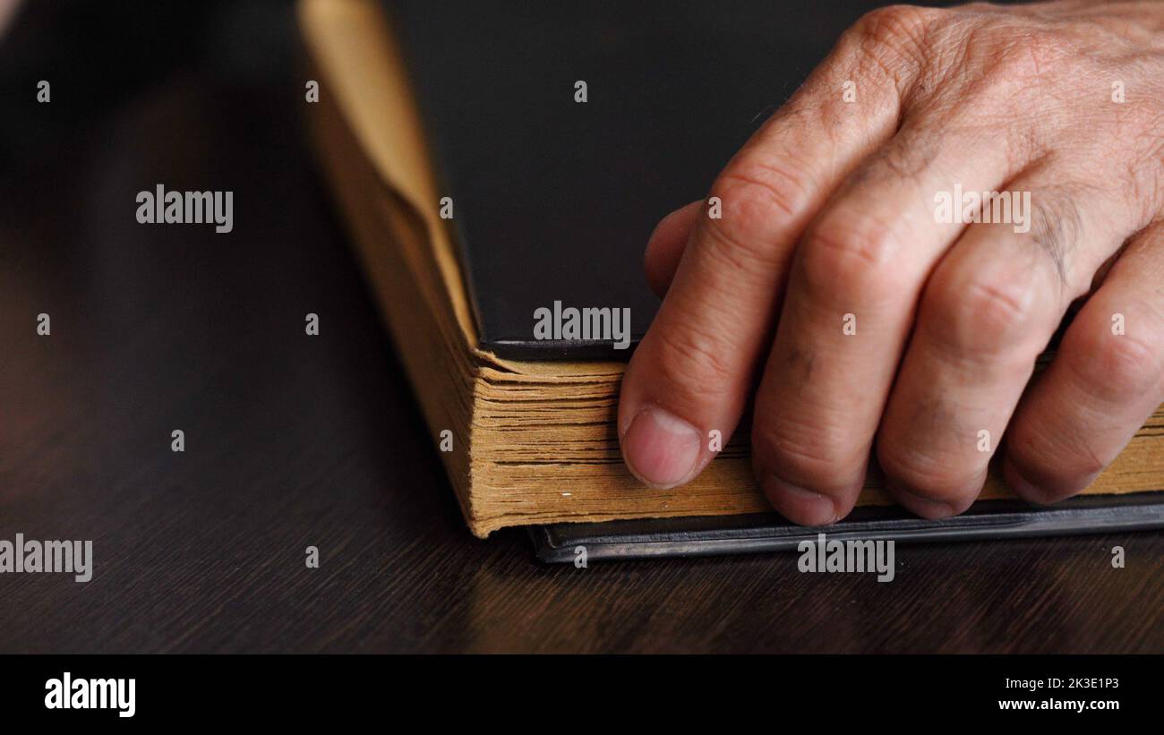 Human hand holding open book hi-res stock photography and images - Alamy
