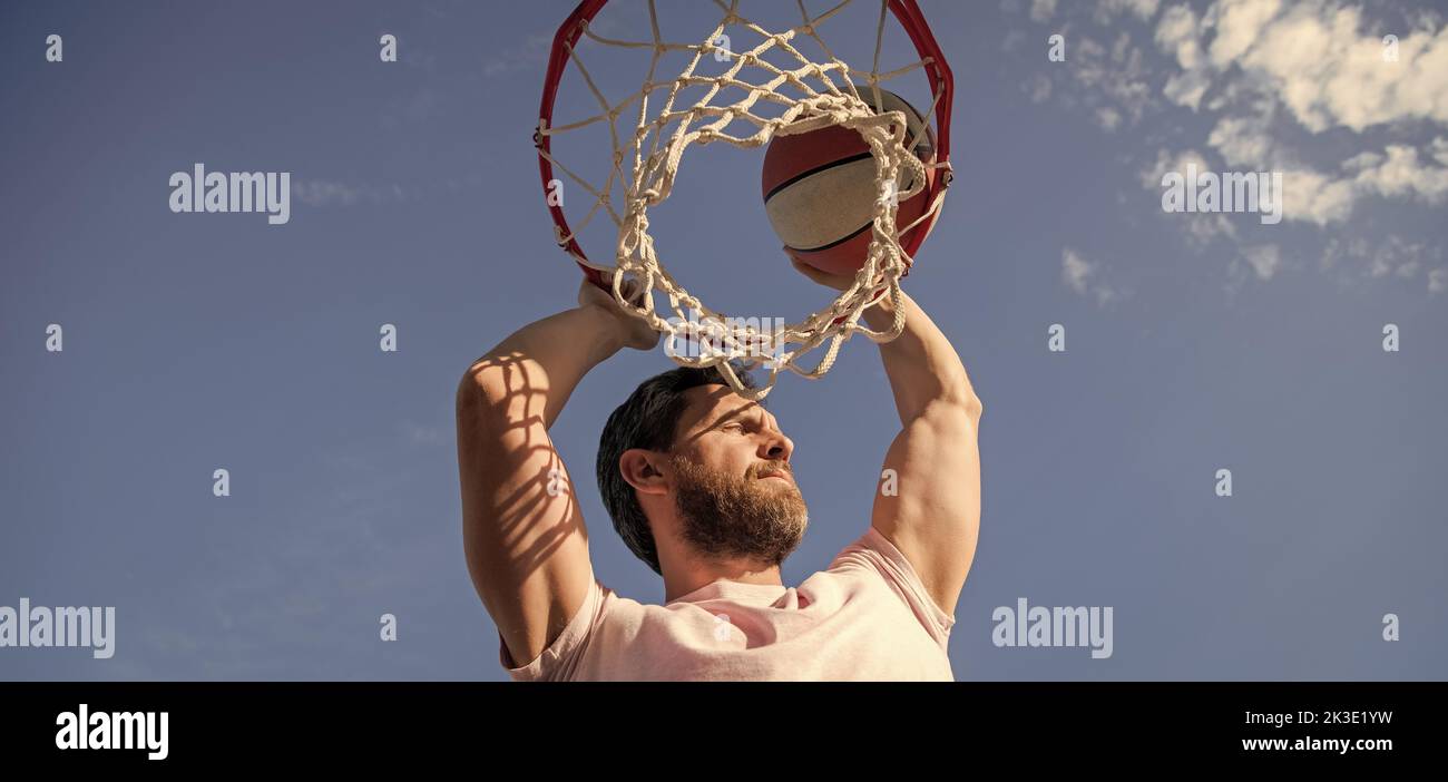 basketball player throws the ball into the hoop outside, sport hobby ...