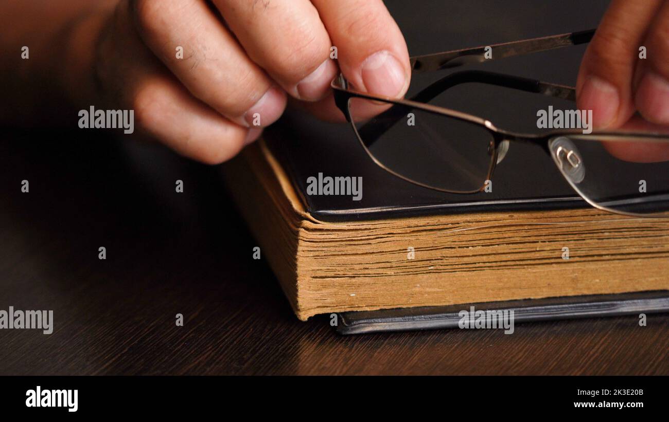 Hand holding book cover hi-res stock photography and images - Alamy