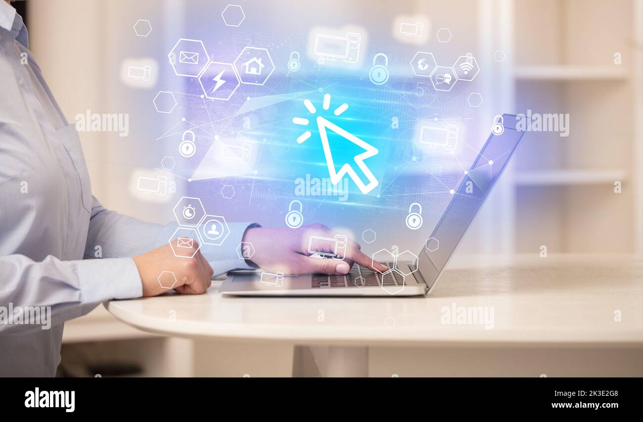Hands working on laptop with digital icons Stock Photo - Alamy
