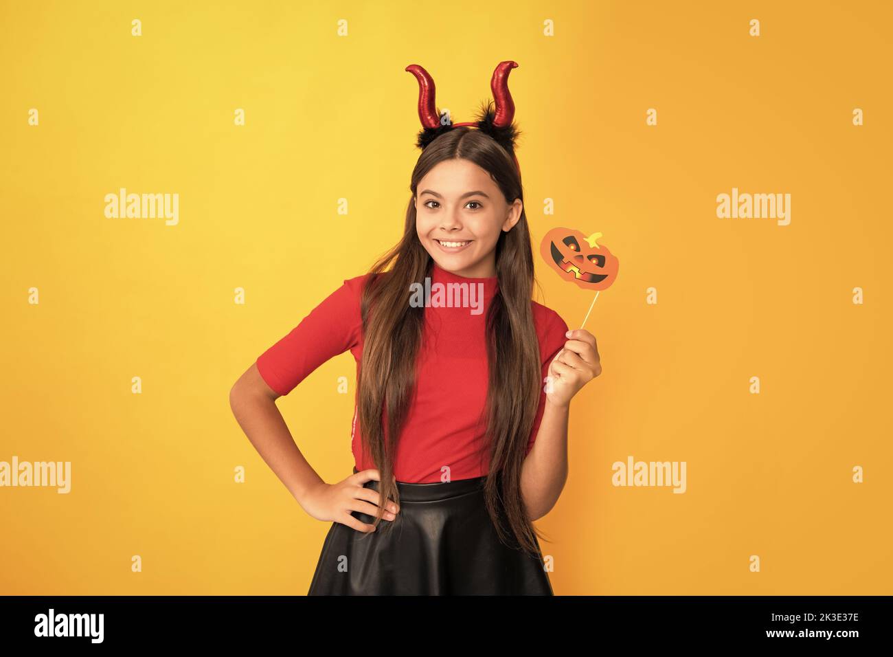 happy halloween. devil kid with pumpkin party accessory. trick or treat ...