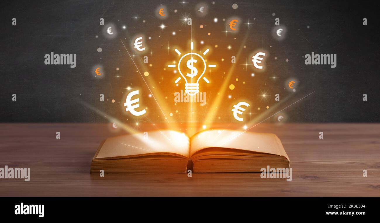 Open book with currency icons above Stock Photo - Alamy