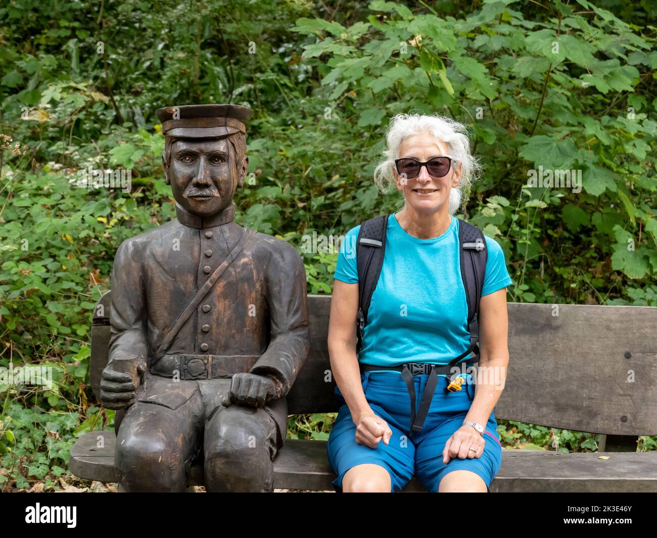 A woman sat on a bench with a carved soldier the Isle of White, UK ...