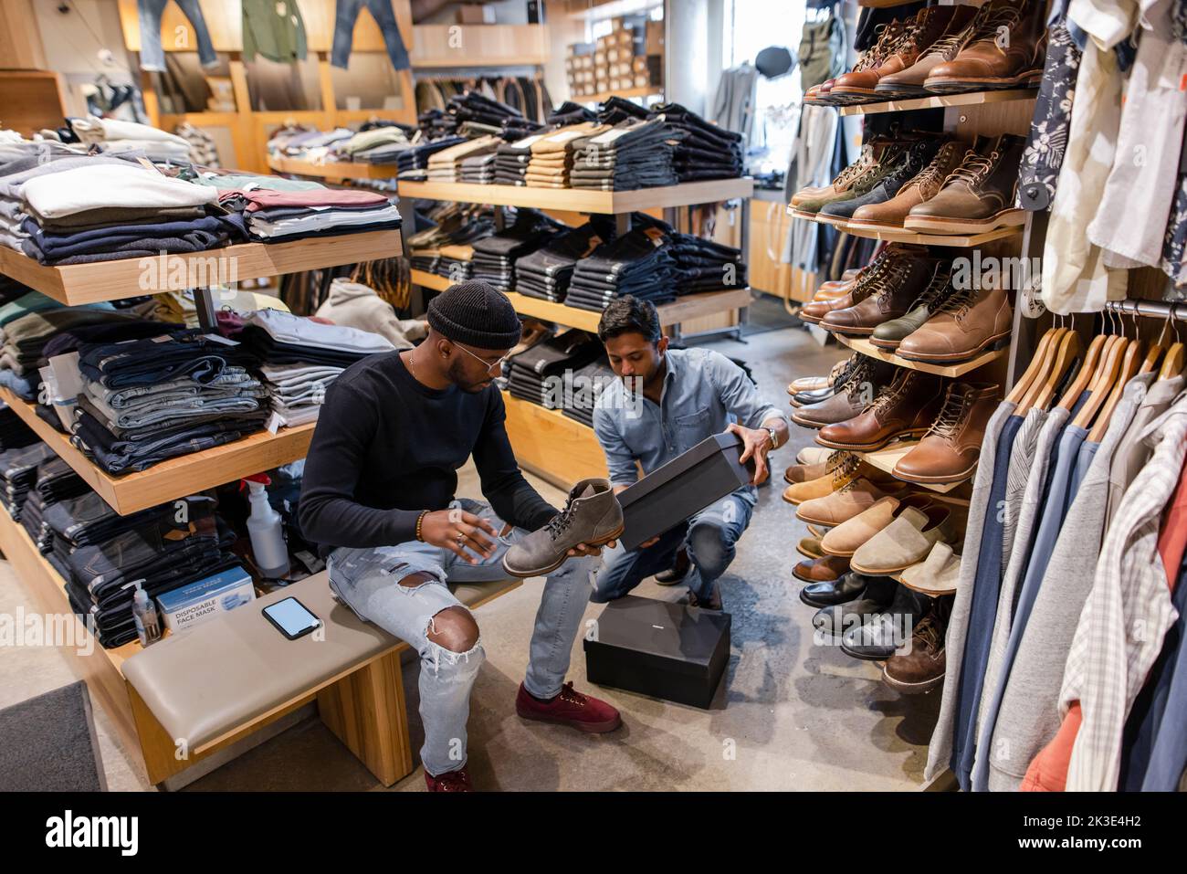 Man trying on shoes in shop hi-res stock photography and images - Alamy