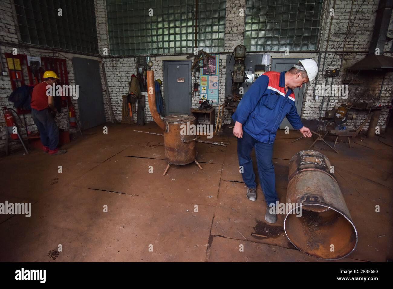 A man looks at a ready-made special metal stove for heating the ...