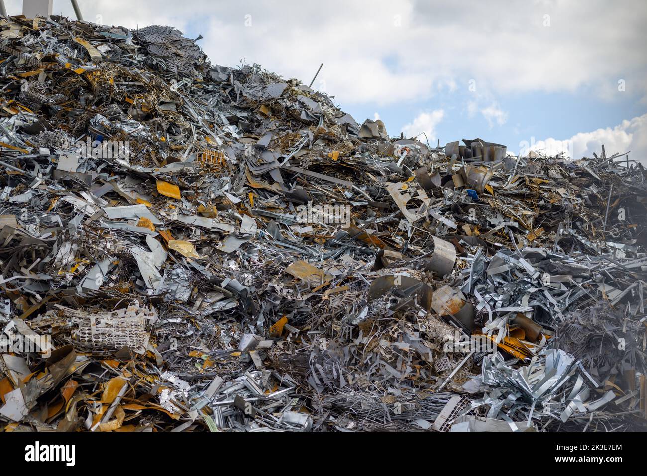 Scrap dealer with a huge mountain of old steel and scrap Stock Photo ...