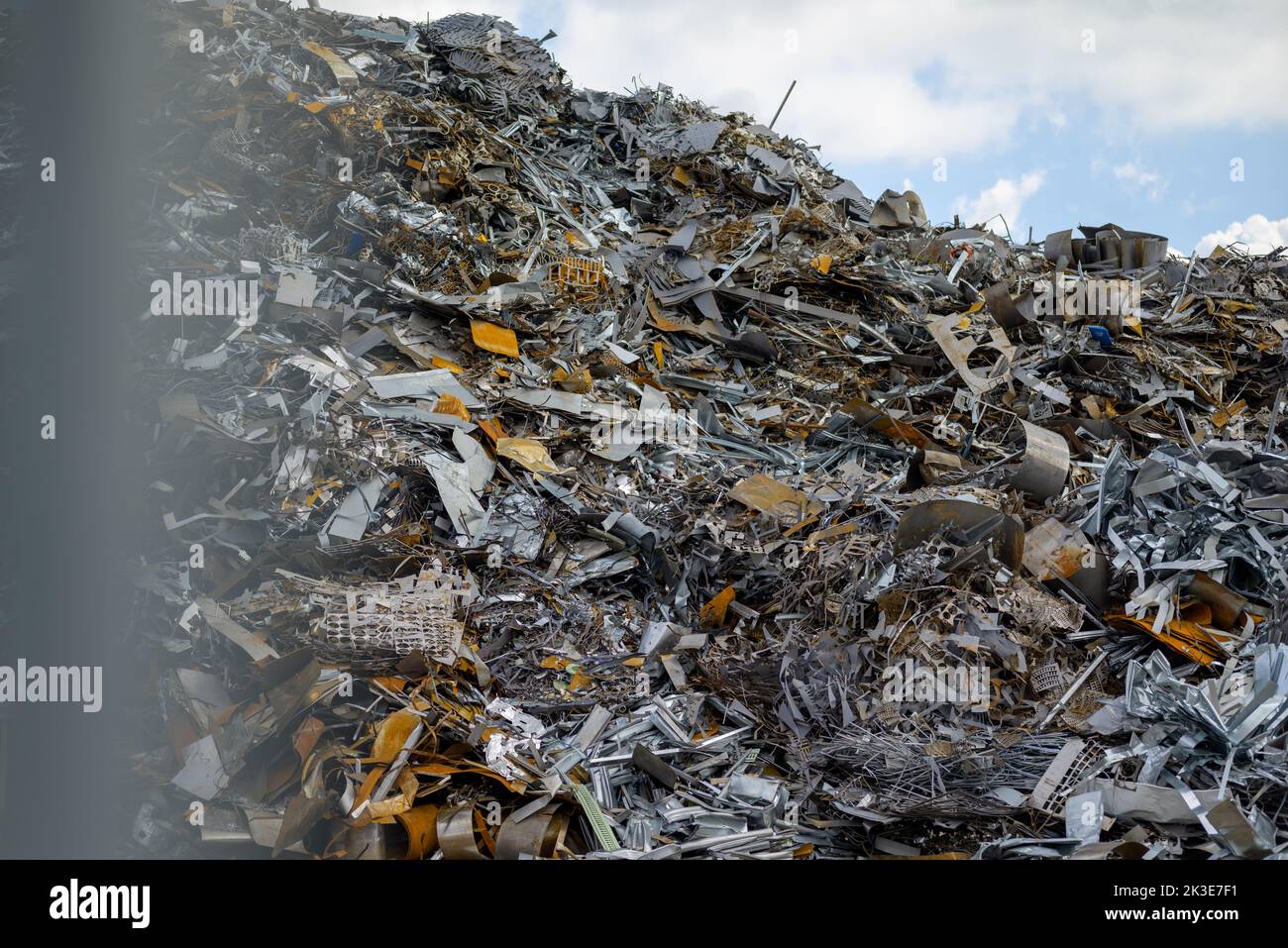 Scrap dealer with a huge mountain of old steel and scrap Stock Photo ...