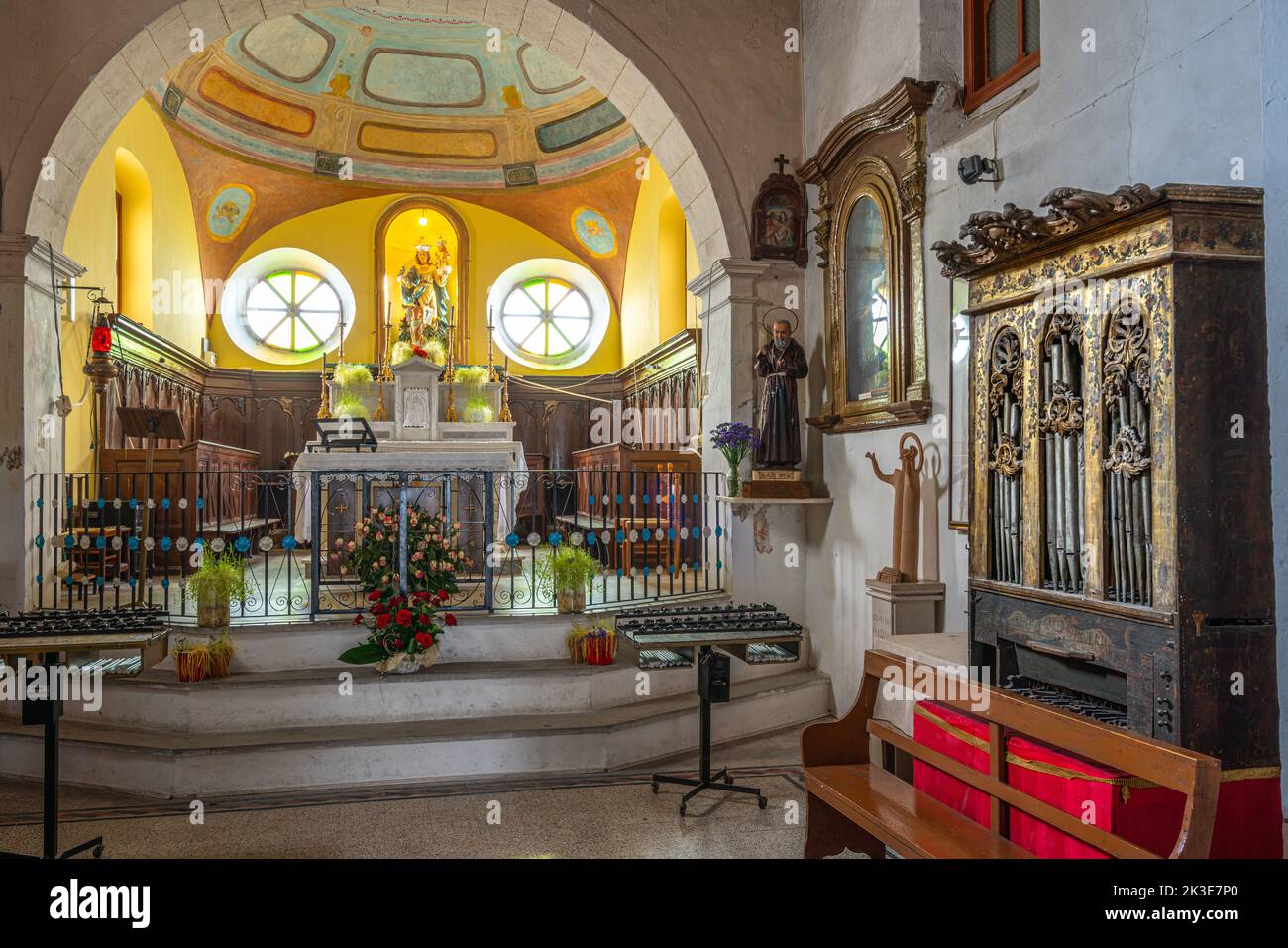 Ancient pipe organ from 1700 and the main altar with the frescoed ...
