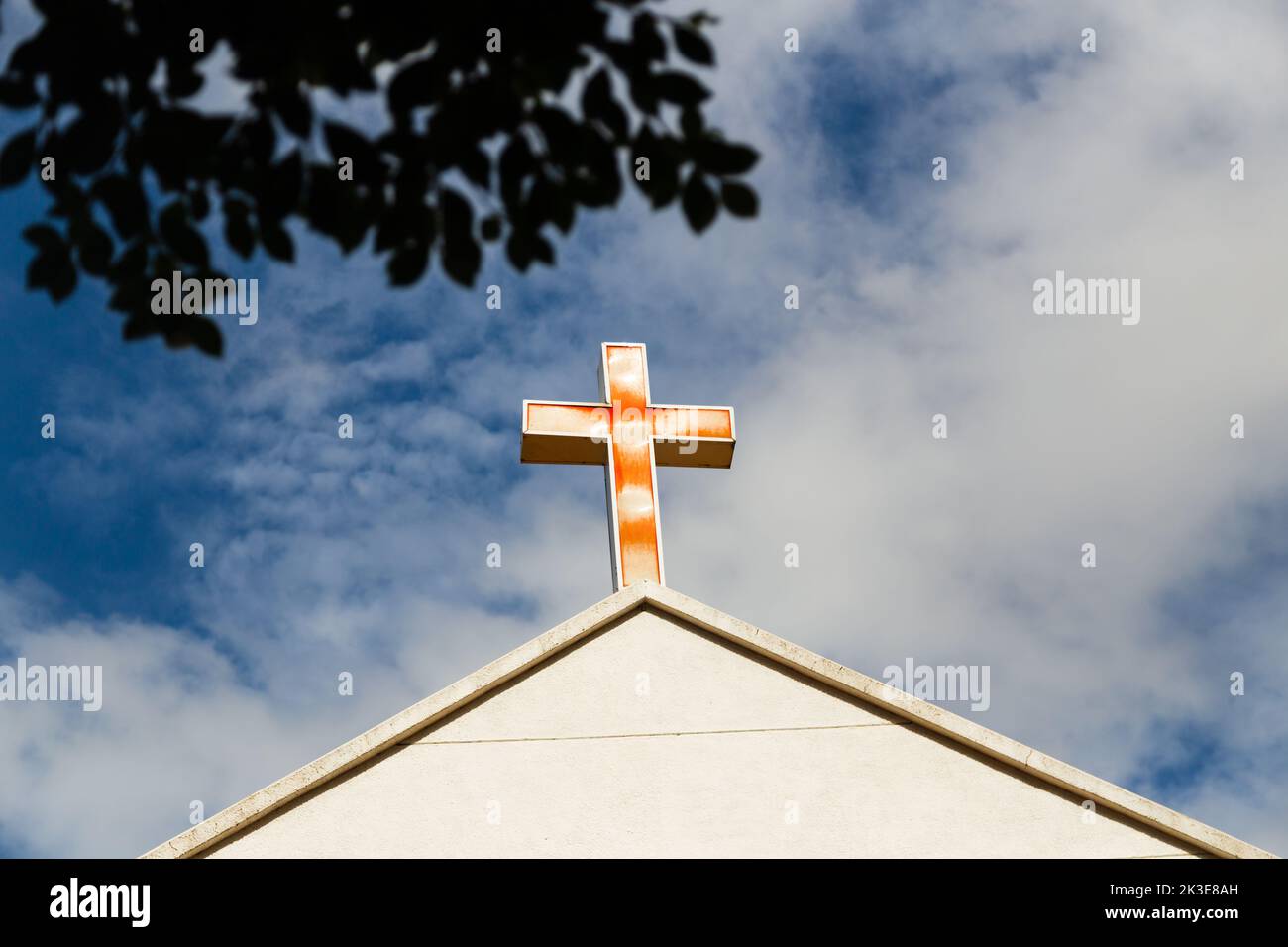 Faded red cross on church roof Stock Photo - Alamy