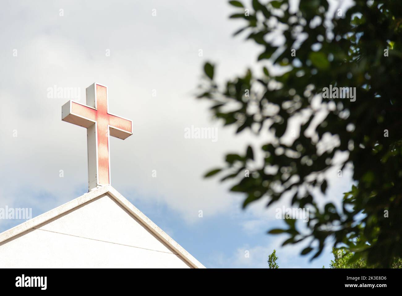 Faded red cross on church roof Stock Photo - Alamy