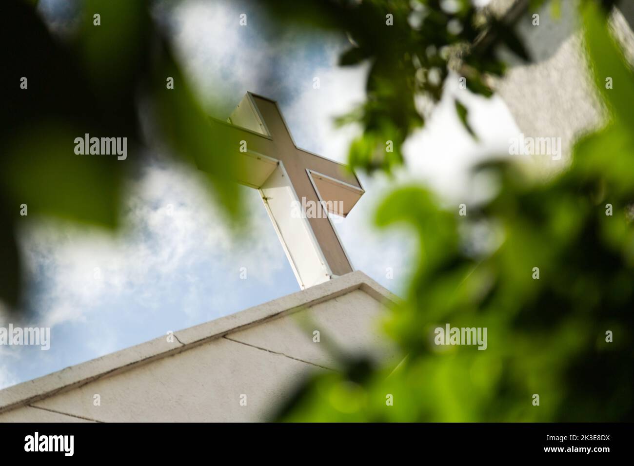 Faded red cross on church roof Stock Photo - Alamy