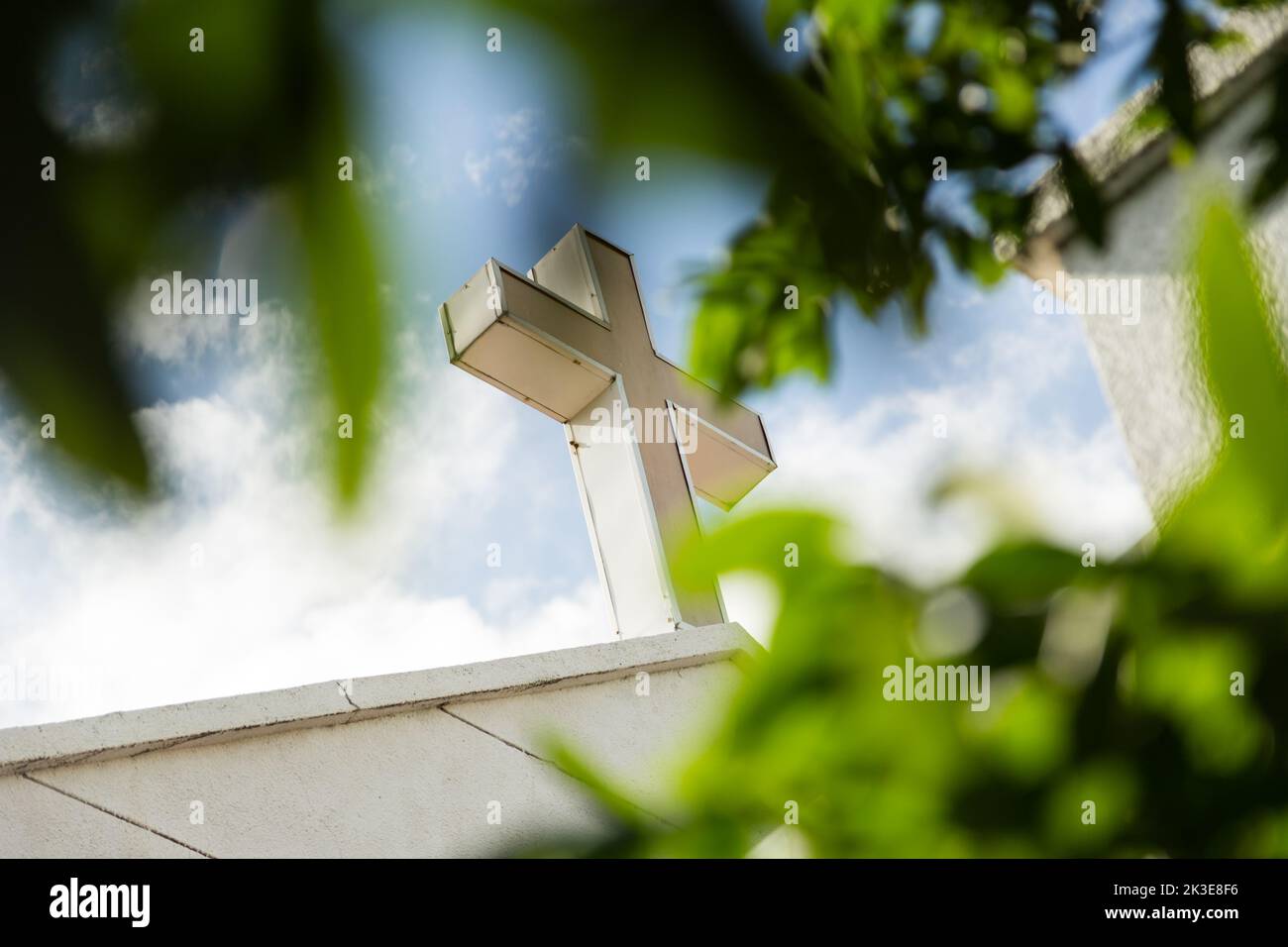 Faded red cross on church roof Stock Photo - Alamy