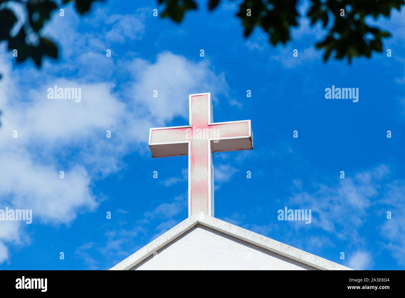 Faded red cross on church roof Stock Photo - Alamy