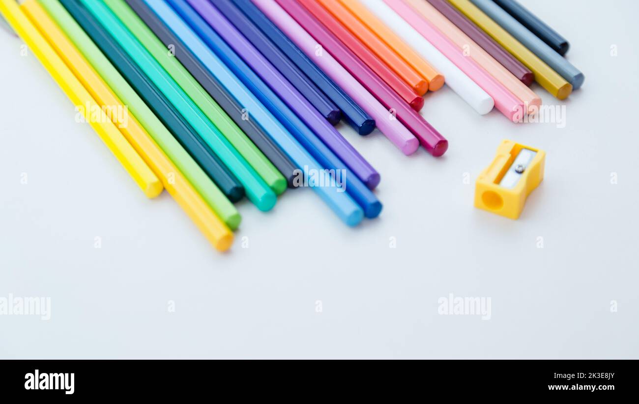 Colored pencil crayons in a row on white background Stock Photo - Alamy
