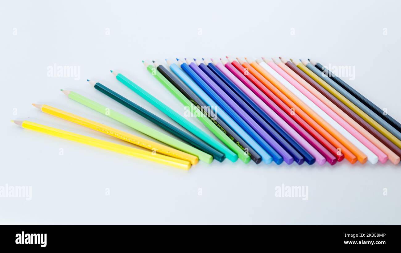 Colored pencil crayons in a row on white background Stock Photo - Alamy