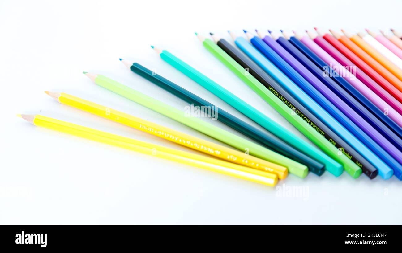 Colored pencil crayons in a row on white background Stock Photo - Alamy