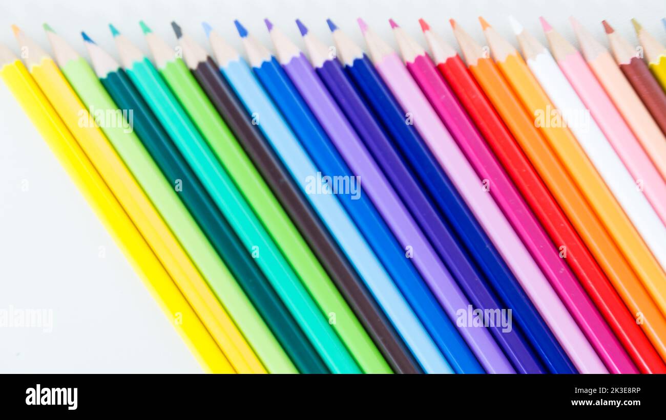 Colored pencil crayons in a row on white background Stock Photo - Alamy