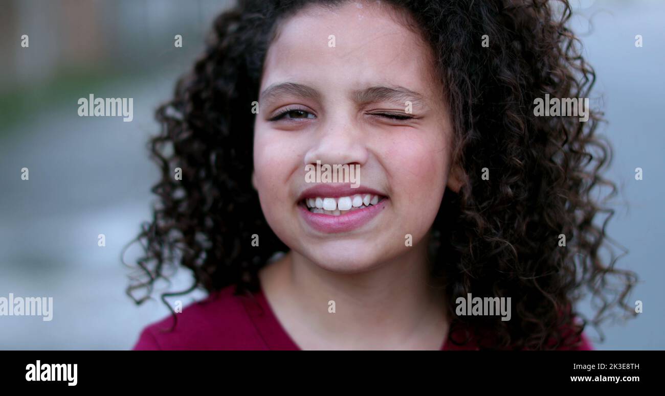 Child winking positive approval to camera portrait face Stock Photo - Alamy