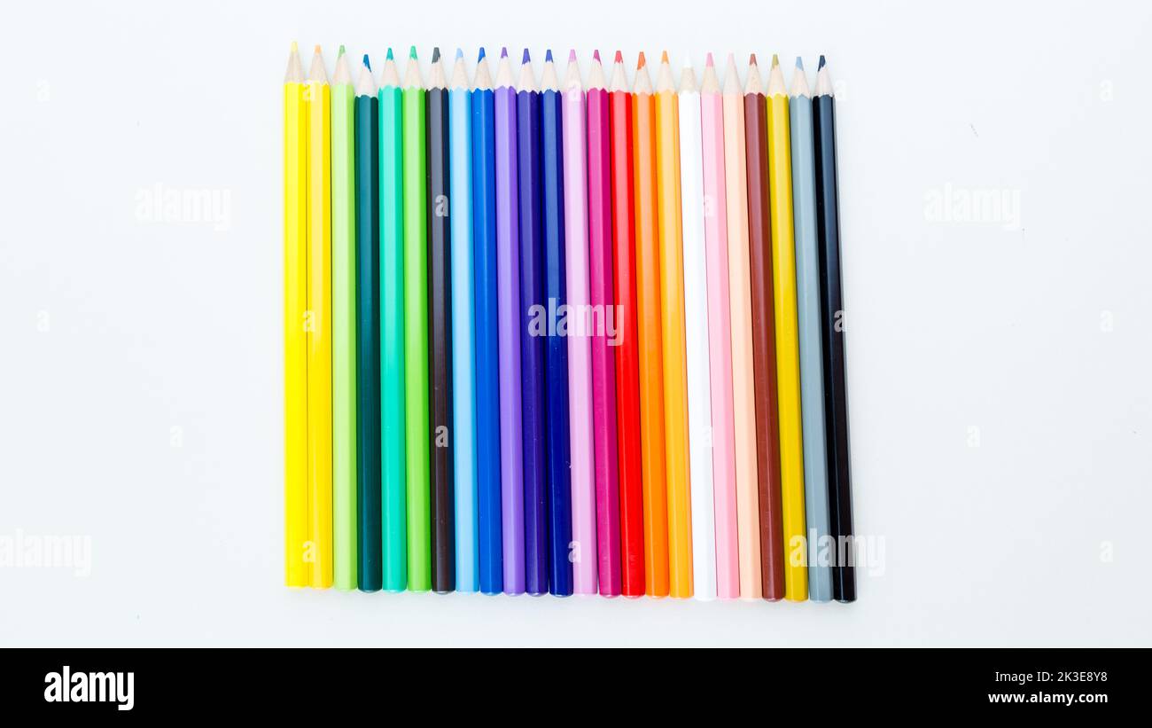 Colored pencil crayons in a row on white background Stock Photo - Alamy