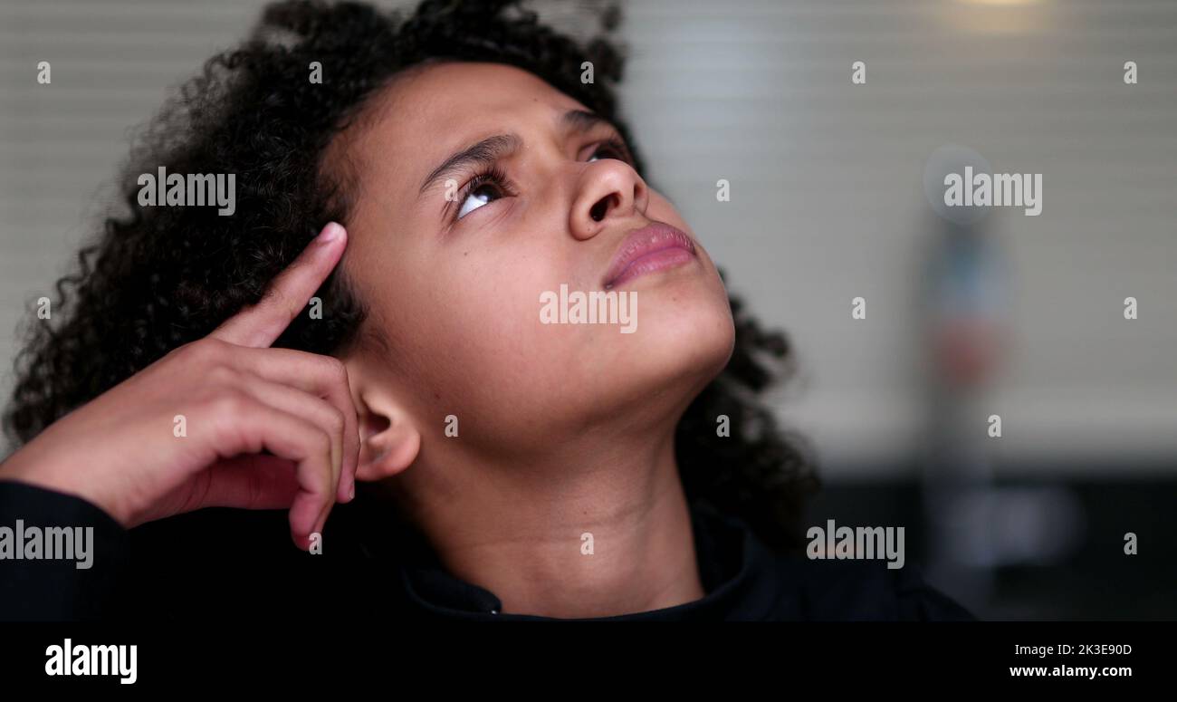 Black little girl thinking pondering problem solving. Thoughtful child ...