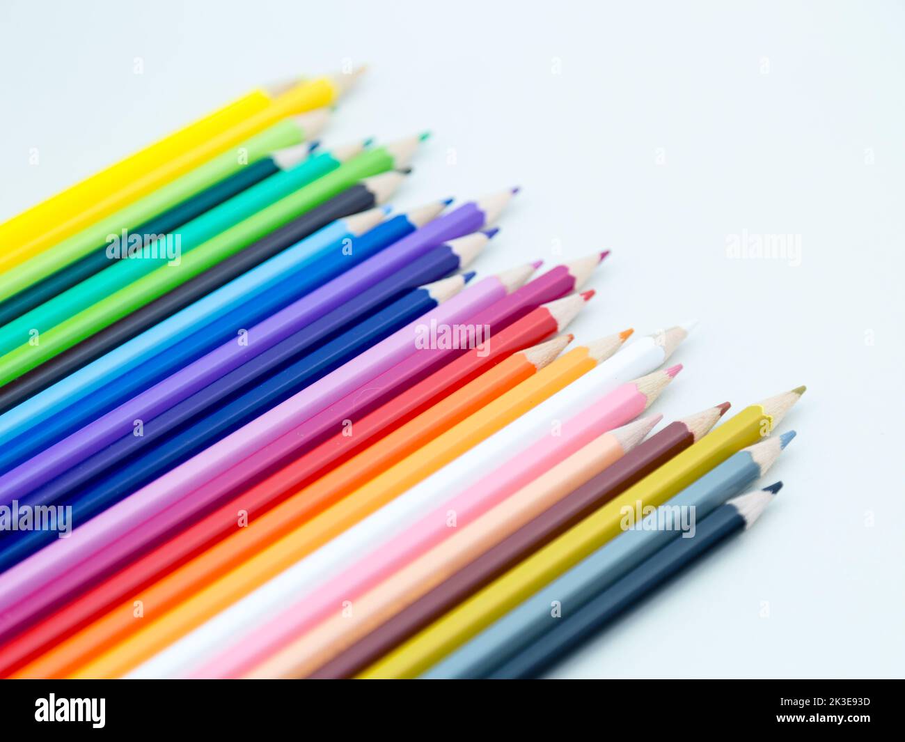 Colored pencil crayons in a row on white background Stock Photo - Alamy