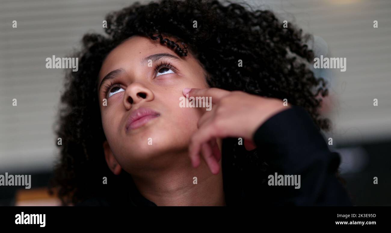 Black little girl thinking pondering problem solving. Thoughtful child ...