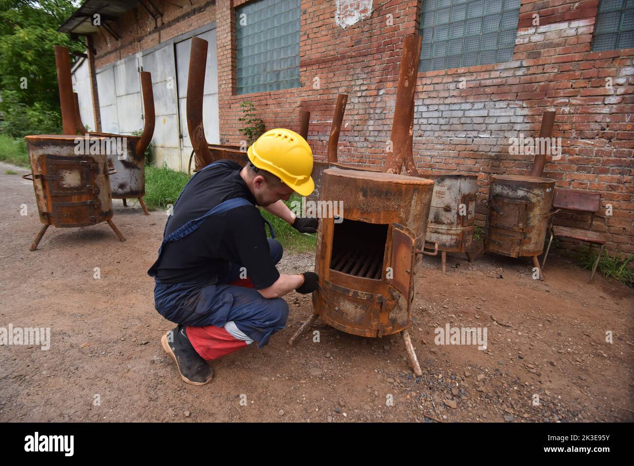 A man looks at a ready-made special metal stove for heating the ...