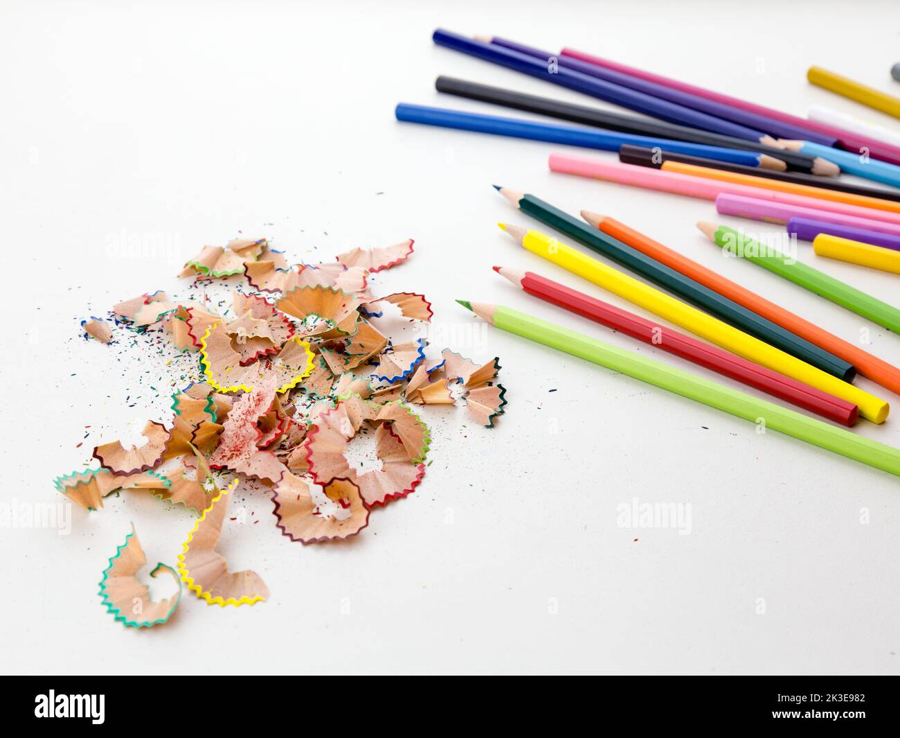 Colored pencil crayons in a row with shavings on white background Stock ...