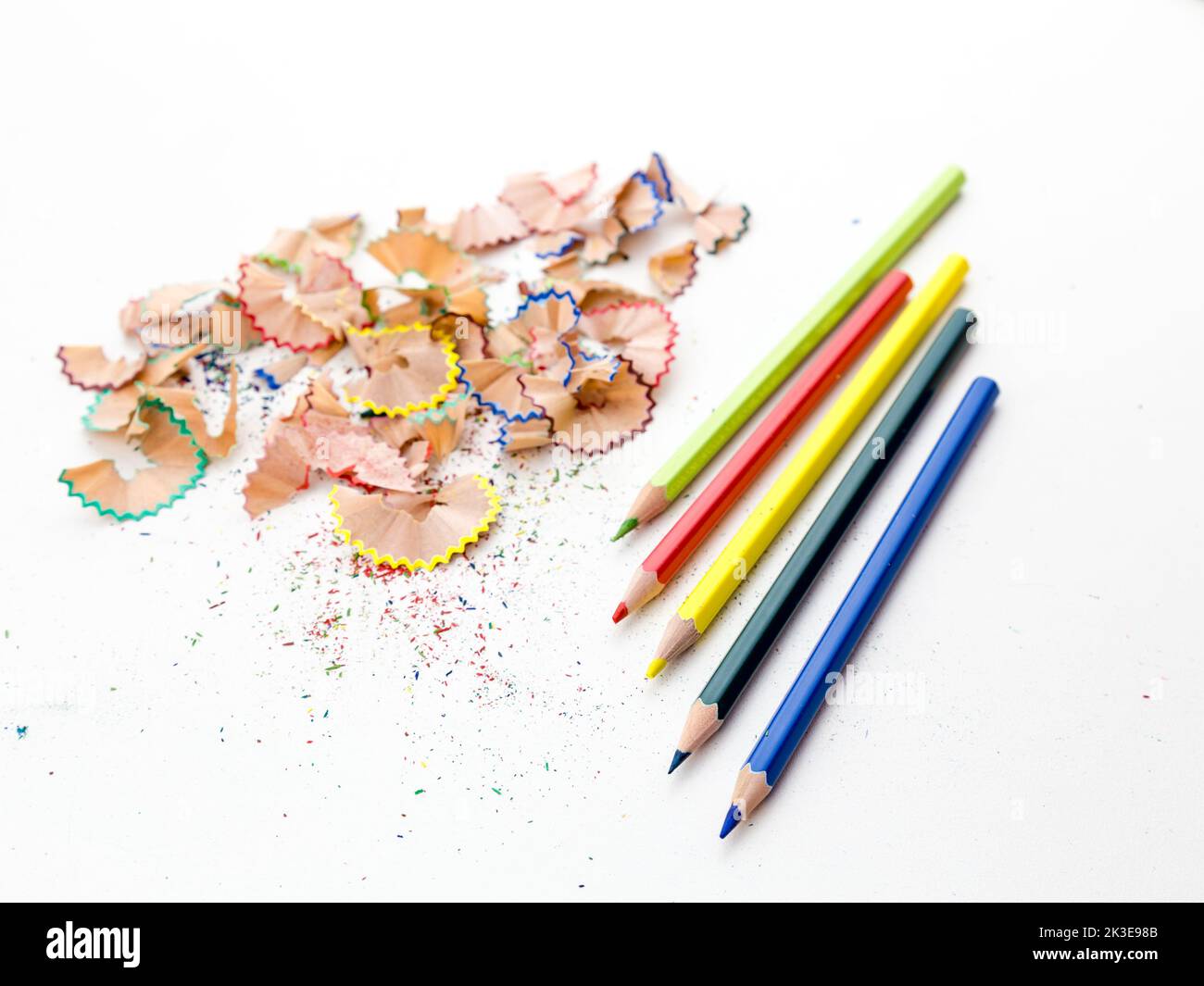 Colored pencil crayons in a row with shavings on white background Stock ...