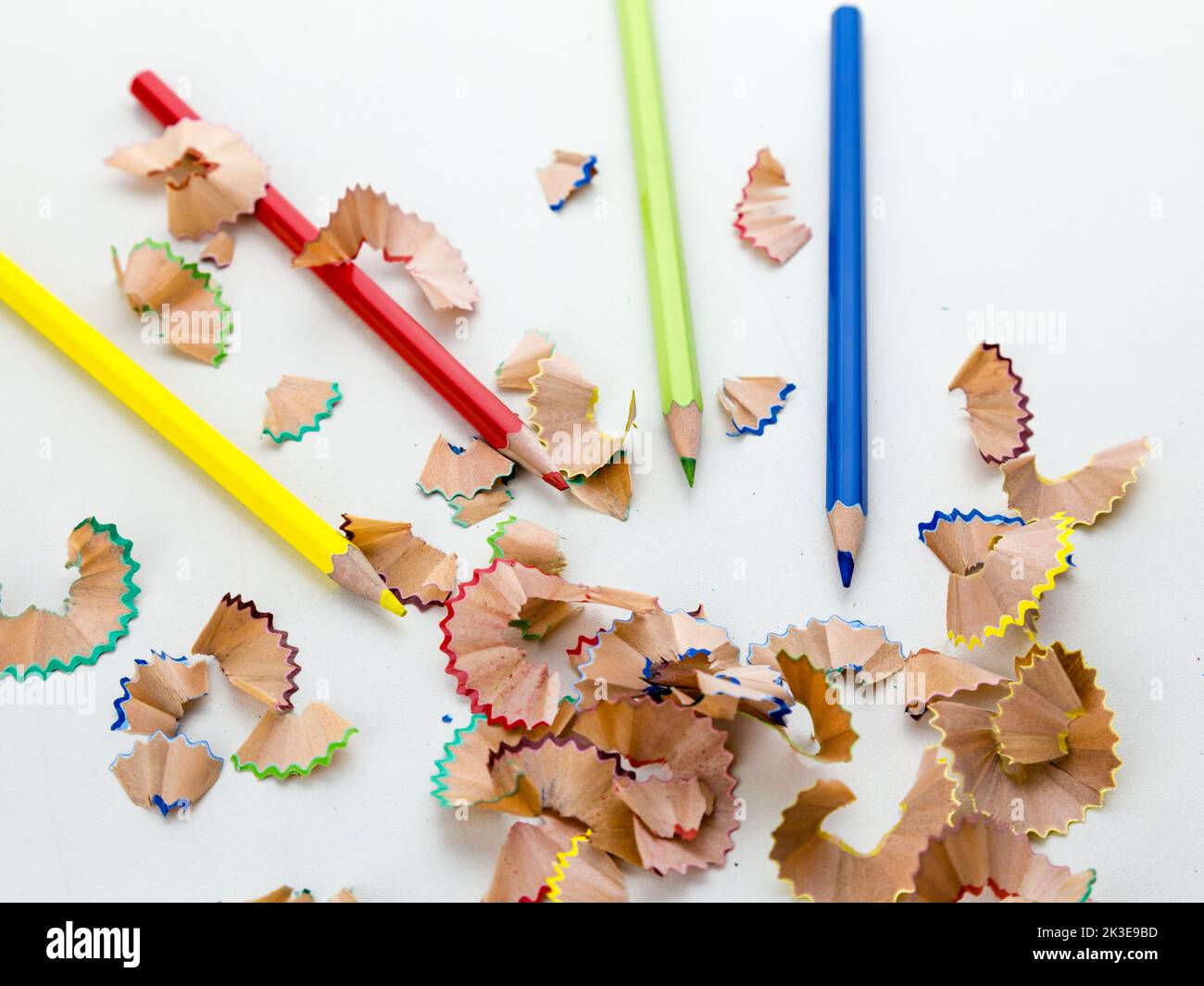 Colored pencil crayons in a row with shavings on white background Stock ...