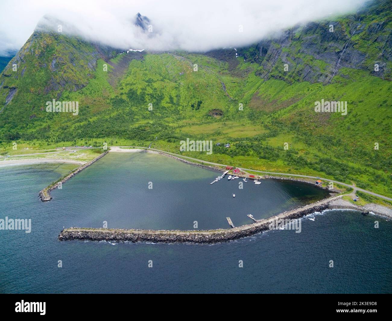Aerial view of sundy Ersfjord beach surrounded by craggy peaks hidden ...