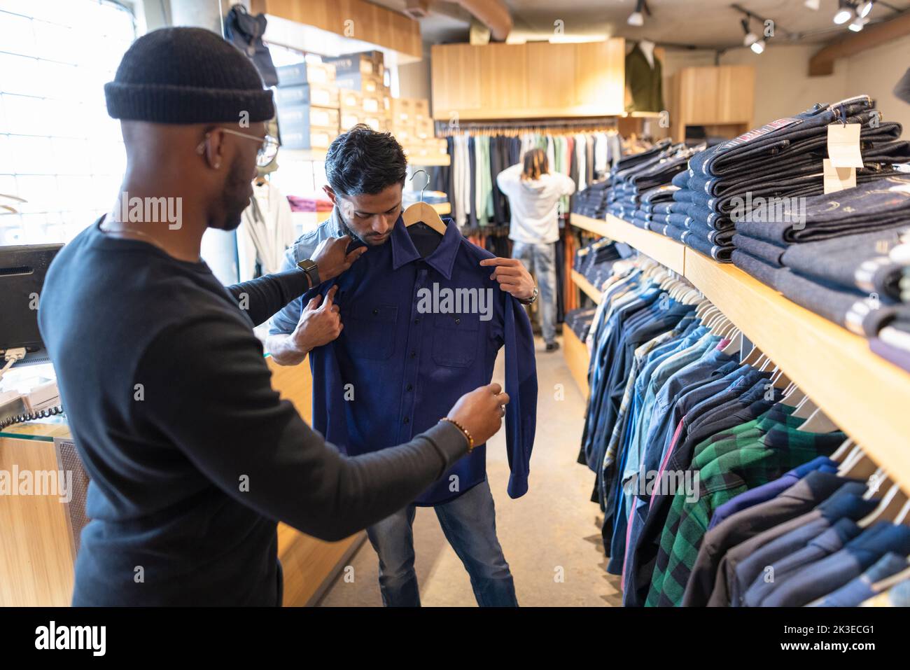 Clothing store owner helping customer hi-res stock photography and ...