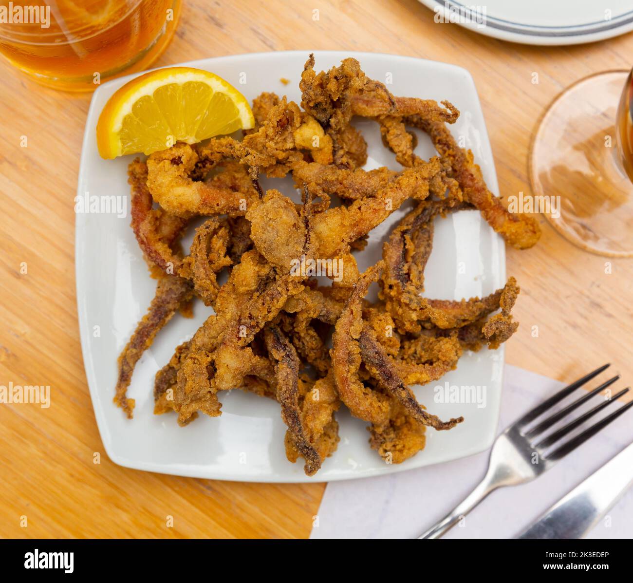 Delicious dish of grilled squid legs in batter Stock Photo - Alamy
