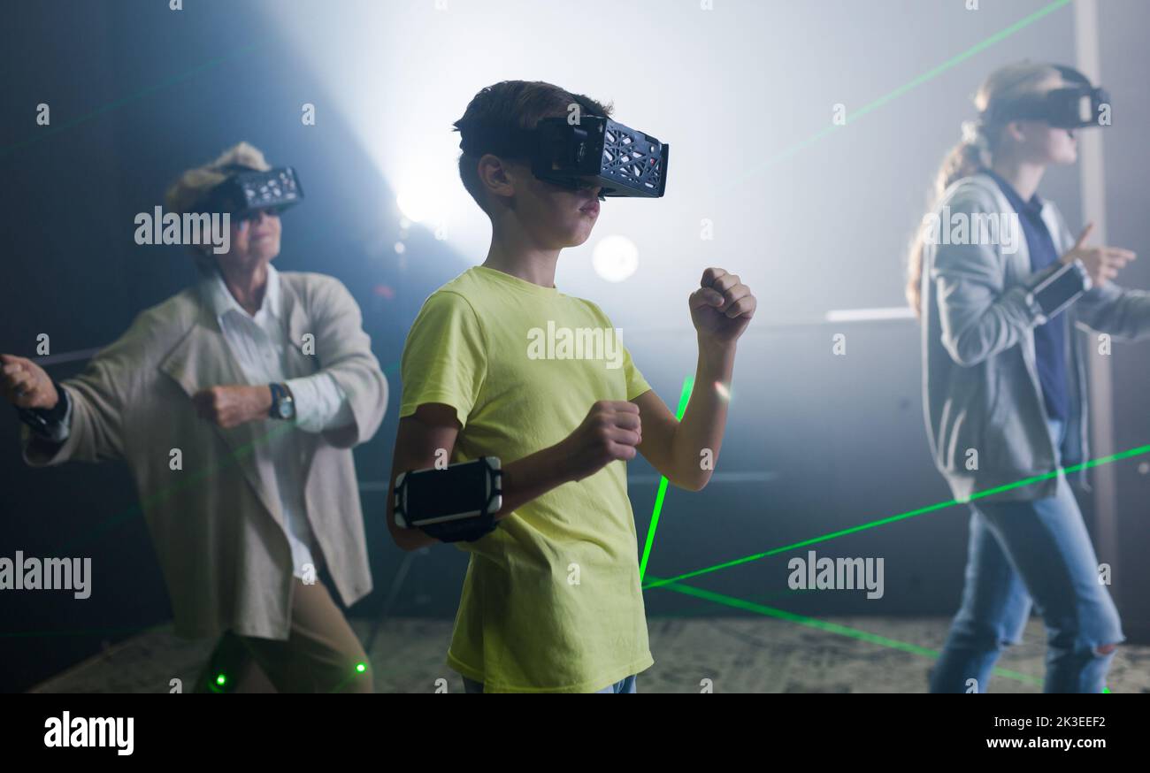 Boy in VR headset playing games with his family Stock Photo - Alamy