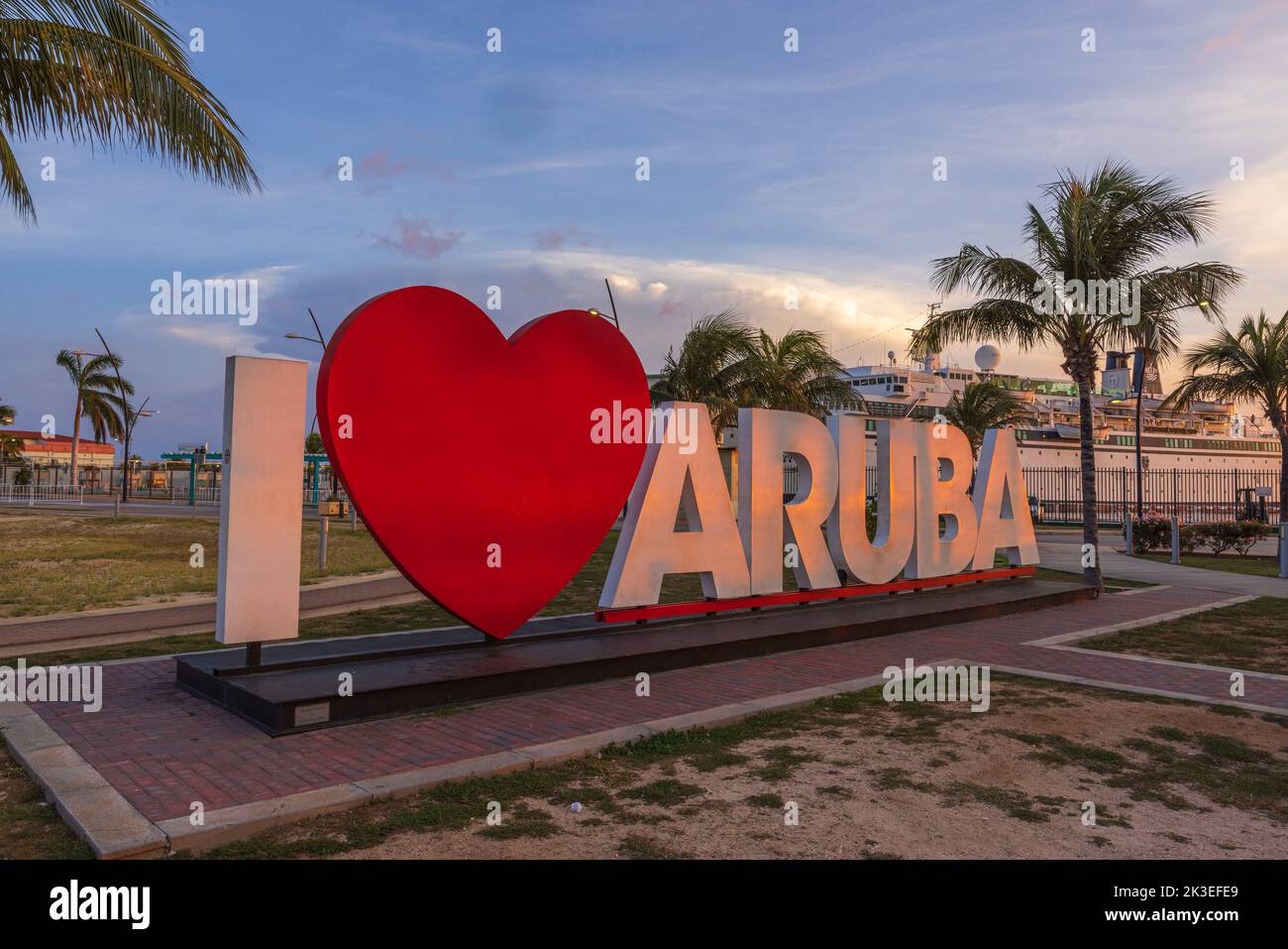 Close up view of large white letters I love Aruba at sunset in center ...