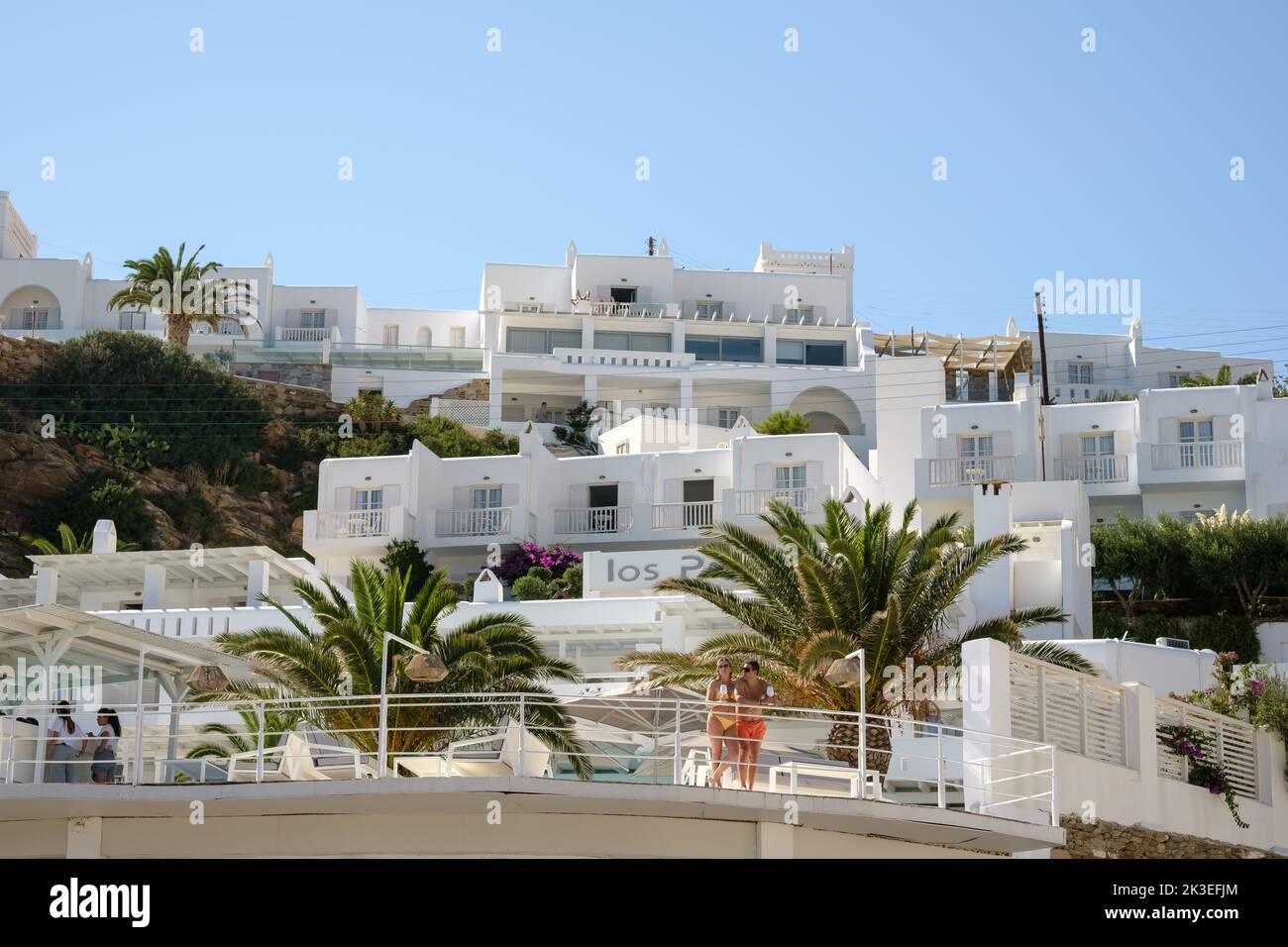 Ios, Greece - September 11, 2022 : A couple having a drink and enjoying ...